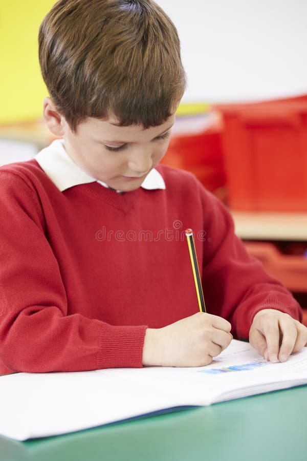 Male Pupil Practising Writing at Table Stock Image - Image of together ...