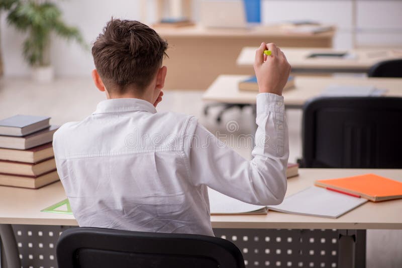 Boy Sitting in the Classrom Stock Photo - Image of preparing, schoolboy ...