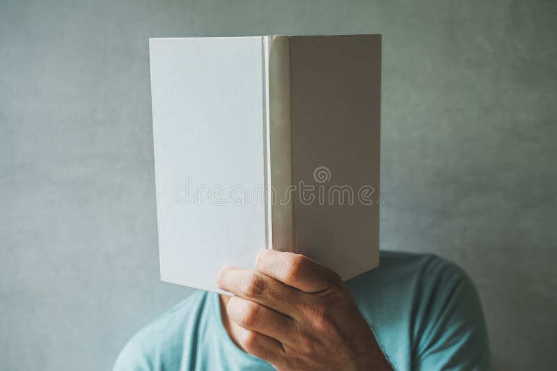 Male Reader Hiding His Face Behind the White Mockup Book Stock Photo ...