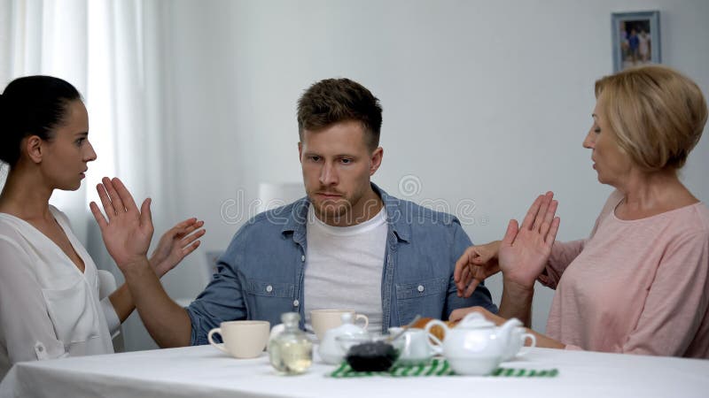 Wife Feeling Confusion Husband And Mother In Law Discussing