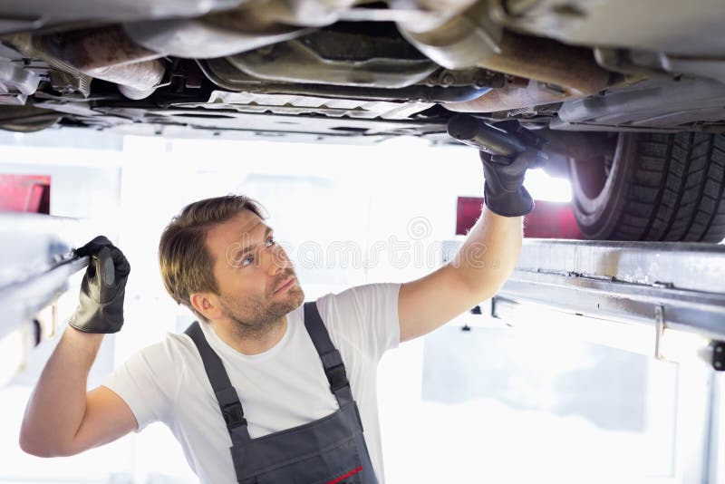 Male Repair Worker Examining Car in Workshop Stock Image - Image of ...