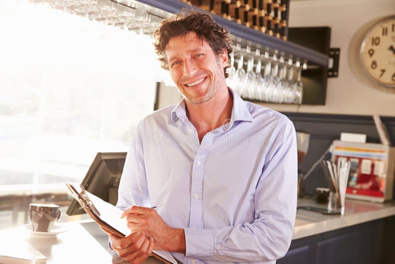 Male Restaurant Manager Holding Clipboard, Portrait Stock Image - Image ...