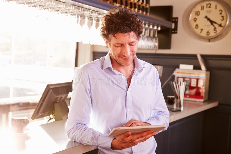 Male Restaurant Owner Owner Using Digital Tablet Stock Image - Image of ...