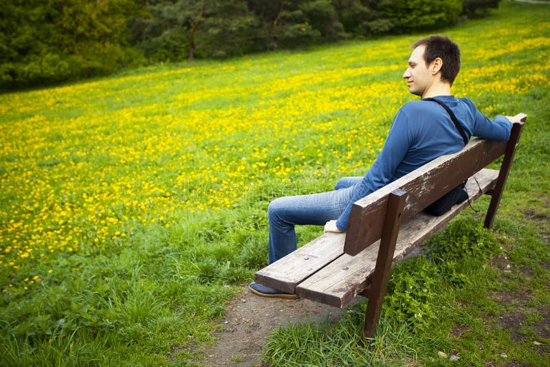 Male resting on the bench stock image. Image of flora - 18206841