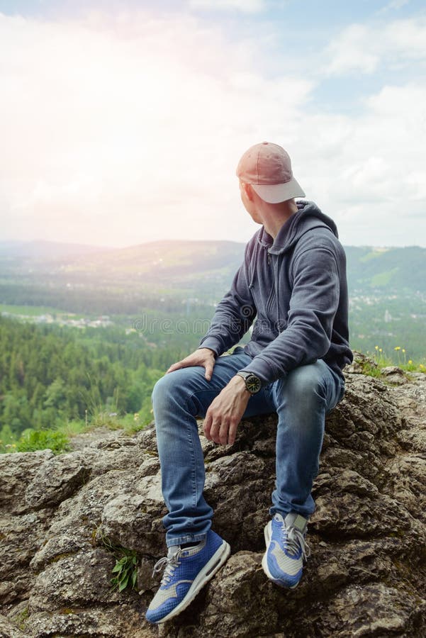 Male Resting and Enjoying the Mountain Sitting on Rock Stock Image ...