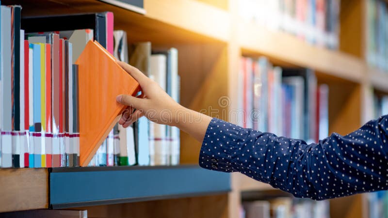Hand Pulling A Book Off The Shelf Stock Image - Image of bookcase ...