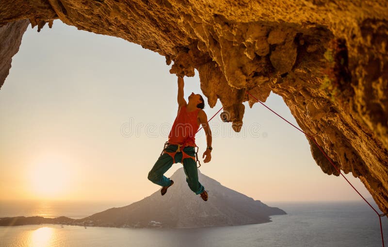 Male Rock Climber Hanging with One Hand on Challenging Route on Cliff ...