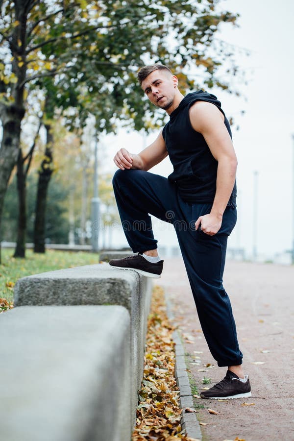 Male Runner Doing Exercise, Workout in the Fall Park. Push Ups with ...