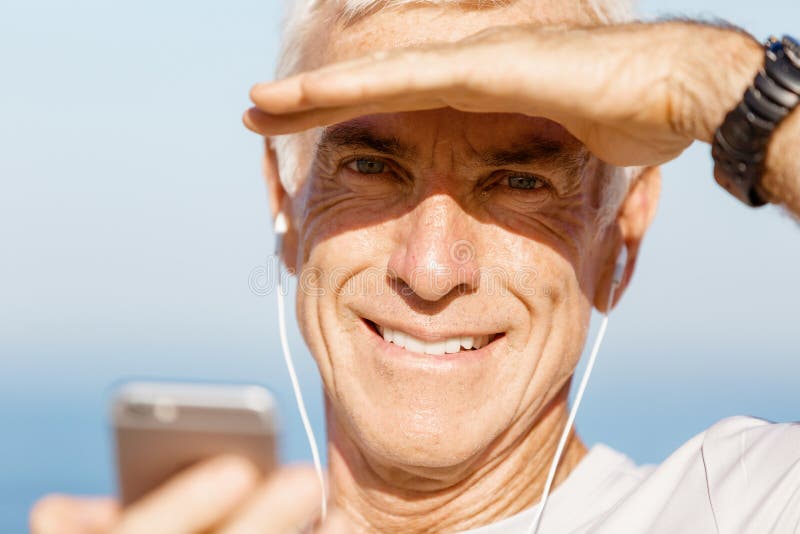 Male Runner with His Mobile Smart Phone Standing Stock Photo - Image of ...
