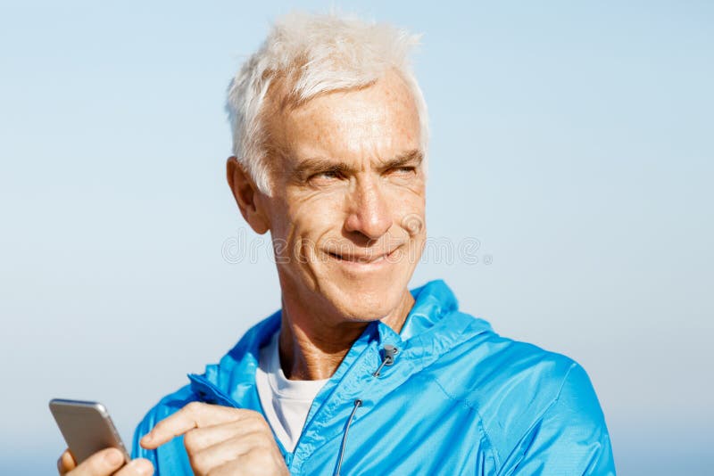 Male Runner with His Mobile Smart Phone Standing Stock Image - Image of ...