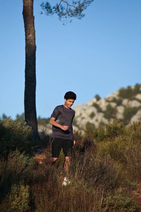Male Runner Jogging through Lovely Landscape Stock Image - Image of ...