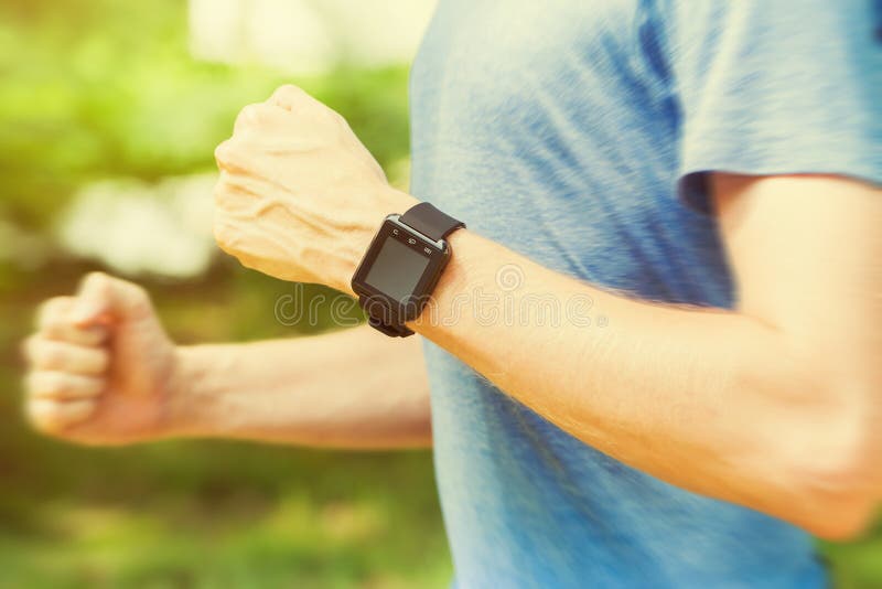 Male Runner Jogging Outside with His Smart Watch Stock Image - Image of ...