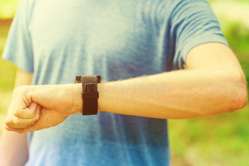Male Runner Looking at His Smart Watch Outside Stock Photo - Image of ...