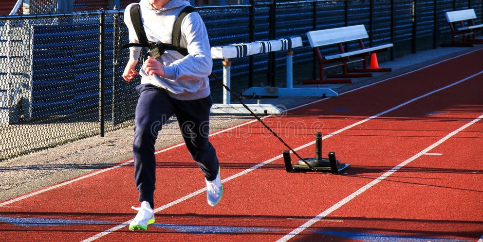 Male Runner Pulling a Sled with Weight on a Track Stock Photo - Image ...