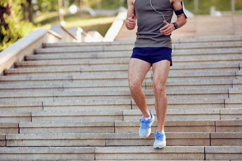 A Male Runner Runs Down the Steps in the Park. Stock Photo - Image of ...