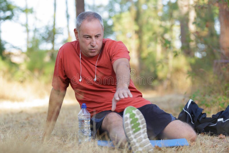 Male Runner Stretching Outdoors in Forest Stock Image - Image of nature ...