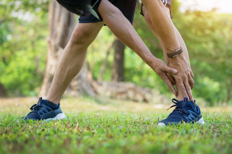 Male Runner Training in Cold Winter Doing Warm-up Leg Stretching Stock ...