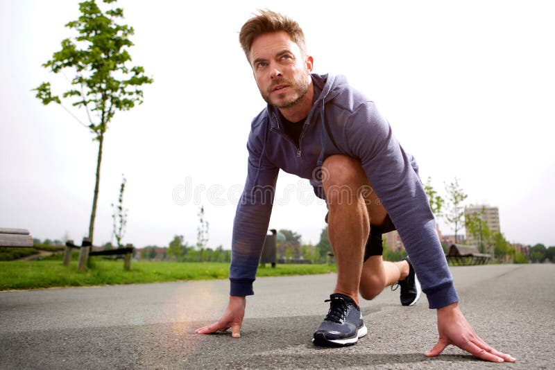 Male Runner Training in Starting Position Stock Image - Image of adult ...
