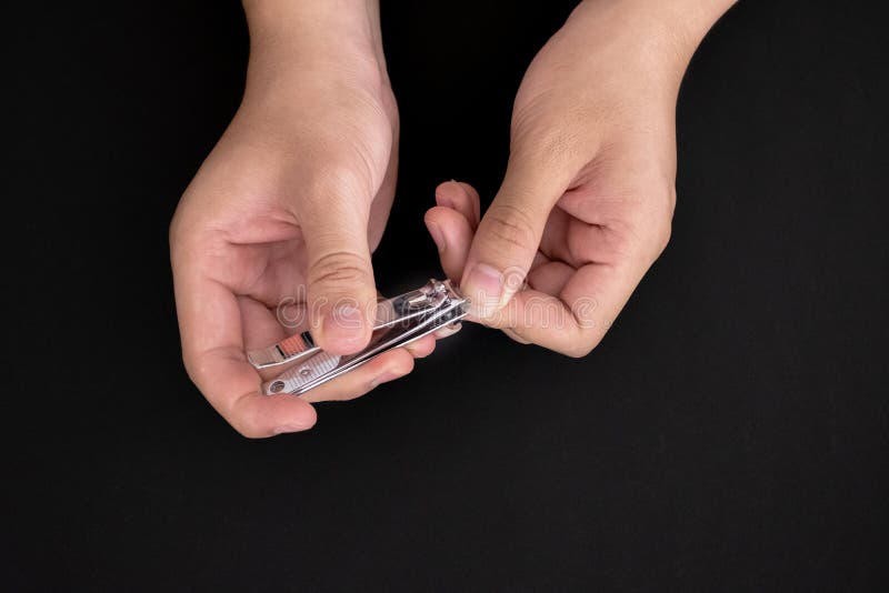 Male`s Hand Holding On Nail Clippers Man Use Nail Clipper Cutting Their