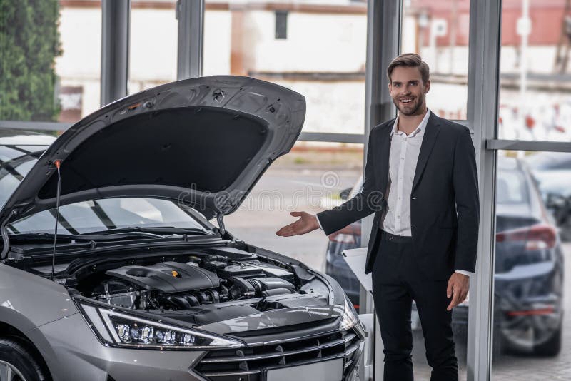 Male Sales Manager on a Car Salon Stock Photo - Image of luxury, grey ...