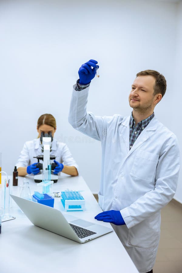 Scientist Man Doing Chemical Experiment, Making Analyzing, Looking ...