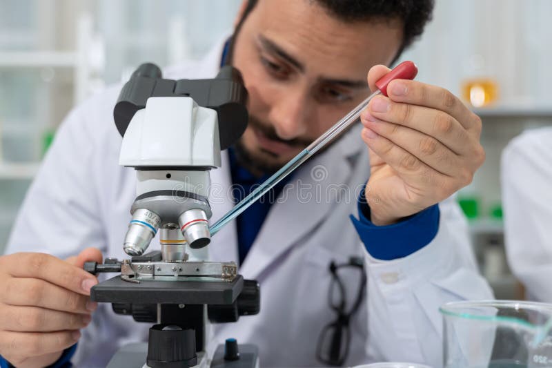 Male Scientist Dropping Chemical Liquid on Slide at Microscope. Science ...