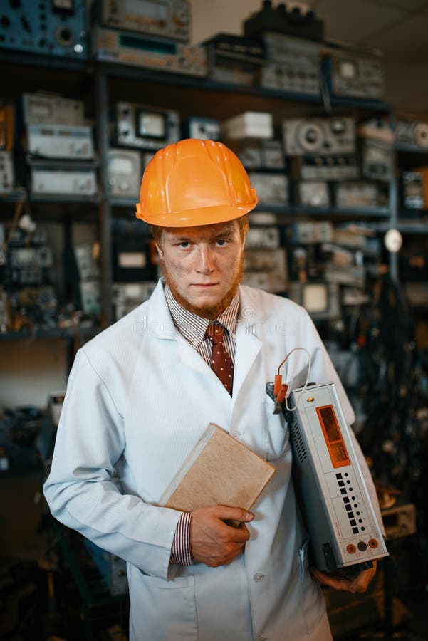 Male Scientist in Helmet Holding a Book and Device Stock Photo - Image ...