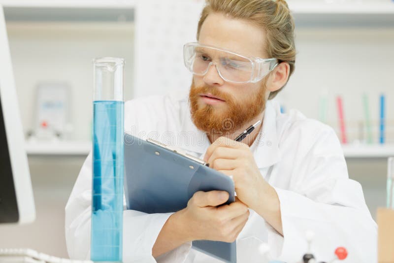 Male Scientist Making Experiment Stock Photo - Image of clipboard ...