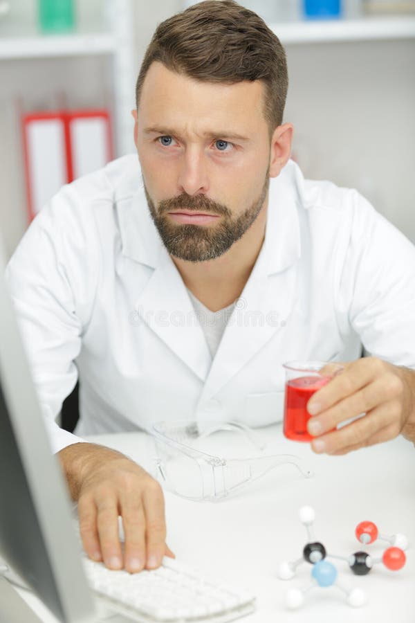 Male Scientist Sitting at Table in Laboratory Stock Photo - Image of ...