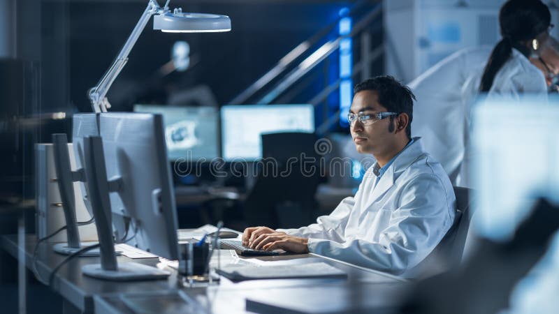 Male it Scientist Uses Computer Showing System Monitoring and ...