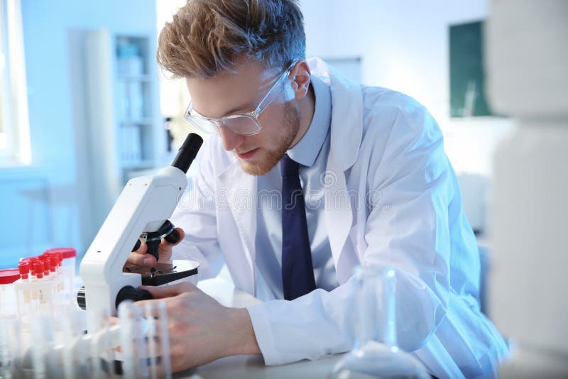 Male Scientist Using Modern Microscope in Chemistry Laboratory Stock ...