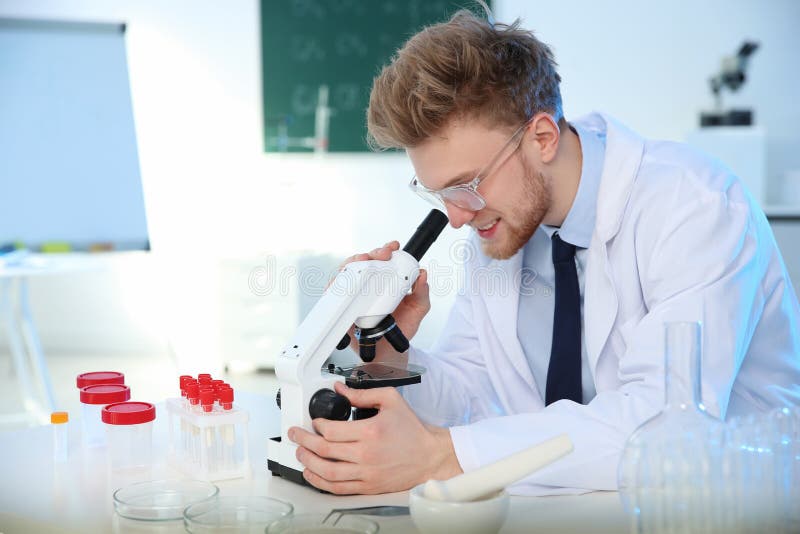 Male Scientist Using Modern Microscope in Chemistry Laboratory Stock ...