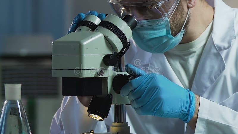 Male Scientist Working with Microscope in Pharmaceutical Industry ...