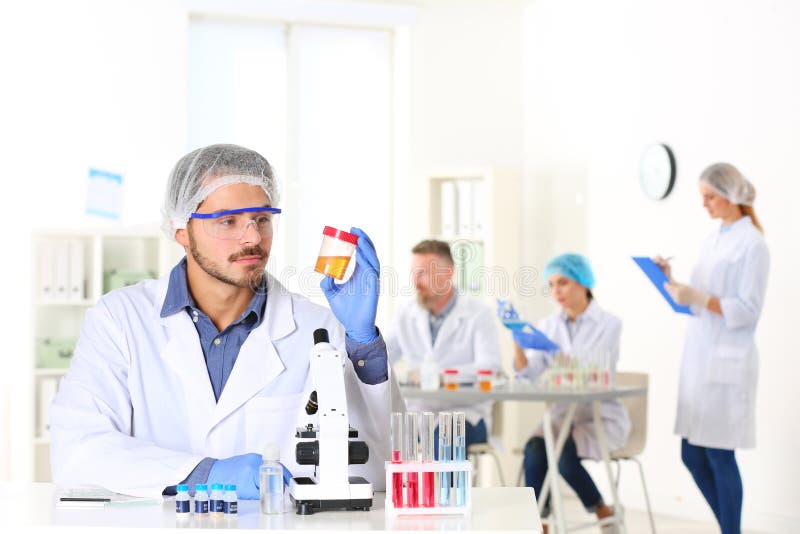 Male Scientist Working at Table in Laboratory Stock Image - Image of ...