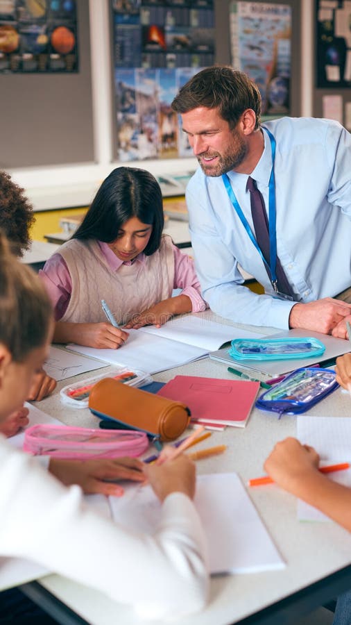 Male Secondary or High School Teacher Sitting at Table Working with ...