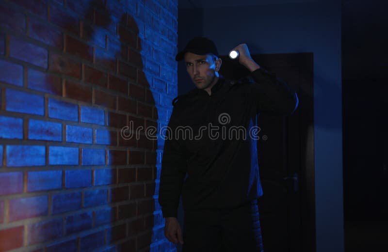 Male Security Guard with Flashlight in Corridor Stock Image - Image of ...