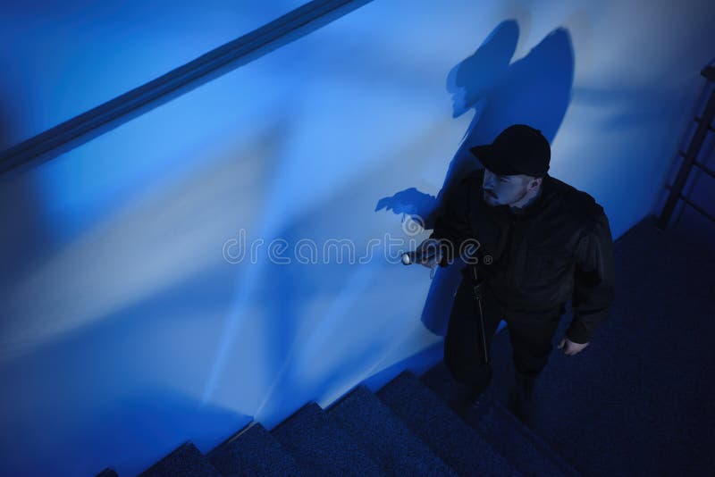 Male Security Guard with Flashlight Going Up Stairs Stock Image - Image ...