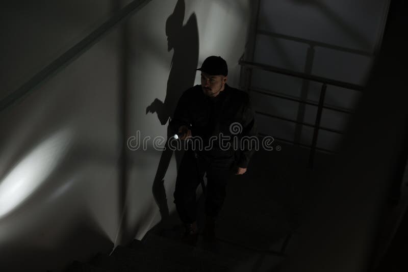 Male Security Guard with Flashlight Going Up Stairs Stock Image - Image ...