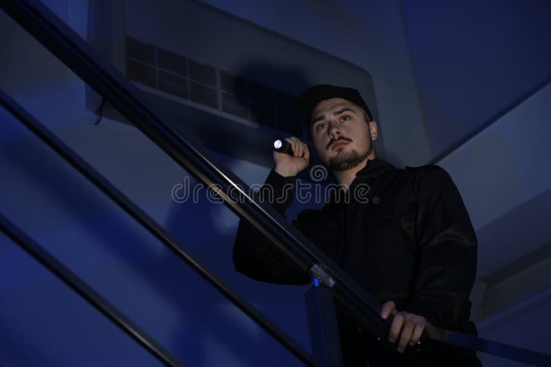 Male Security Guard with Flashlight on Stairs Stock Photo - Image of ...