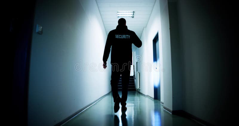 Male Security Guard Holding Flashlight Standing in Corridor Stock Image ...