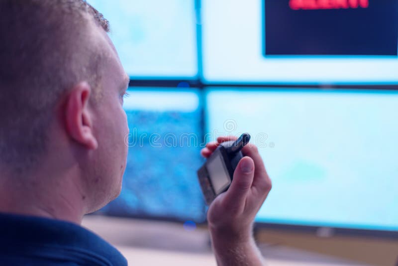 Male Security Guard Operator Talking on the Phone, Calling in the ...