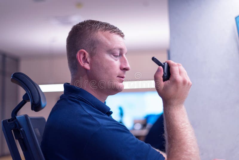 Male Security Guard Operator Talking on the Phone, Calling in the ...