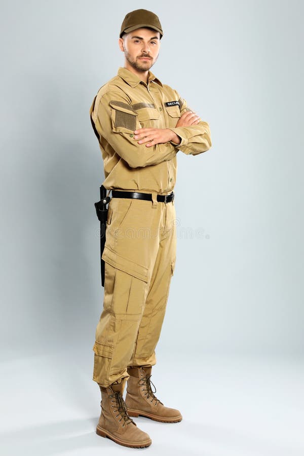 Male Security Guard in Uniform on Grey Stock Photo - Image of crossed ...