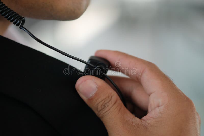 Male Security Guard Using Portable Radio Outdoors Stock Image - Image ...