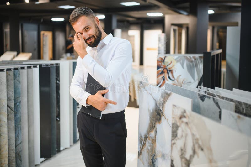 A Male Seller of Ceramic Tiles in a Hardware Store Stock Photo - Image ...