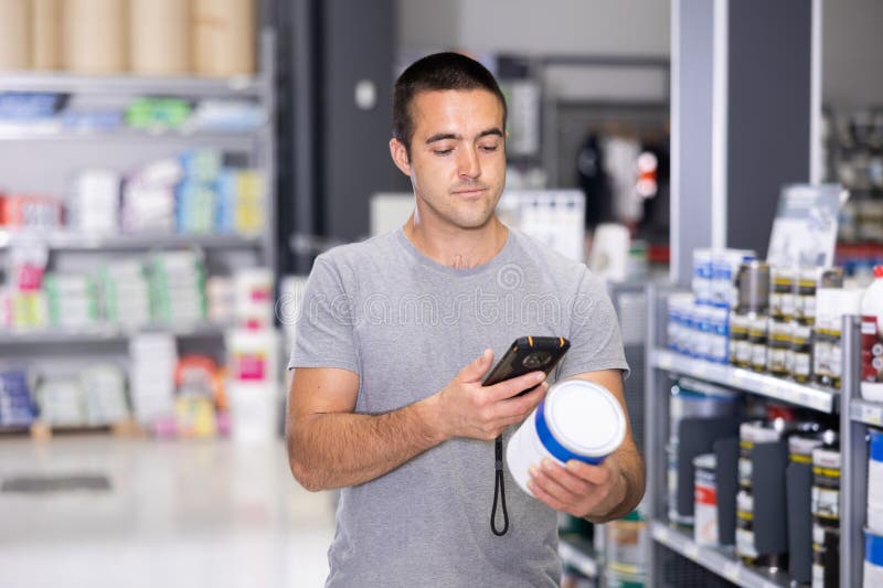 Male Shopper Scanning a QR Code Using a Mobile Phone in Hardware Store ...