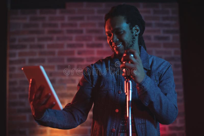 Male Singer Using Digital Tablet while Performing at Music Concert ...