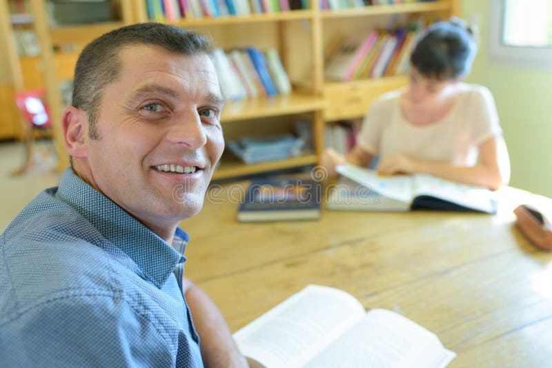 Male Smiling Inside Library Stock Image - Image of paper, bookshelf ...