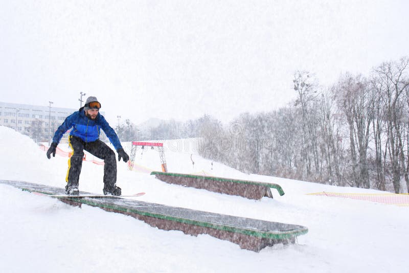 Male Snowboarder Doing Trick at Winter Resort Stock Image - Image of ...