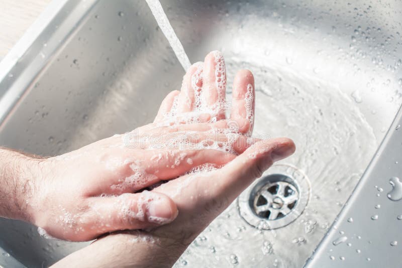 Male Soaping His Hands Next To Pouring Water at a Kitchen Sink Stock ...